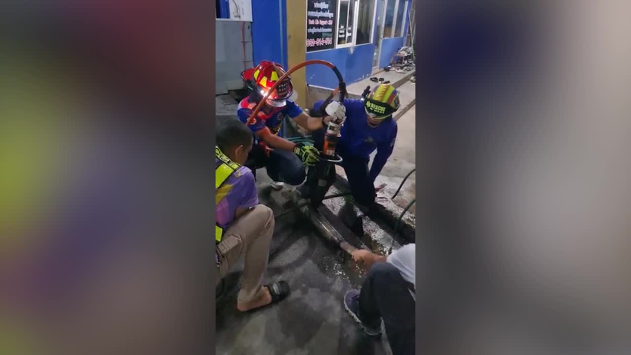 Firemen rescue monitor lizard stuck in pipe