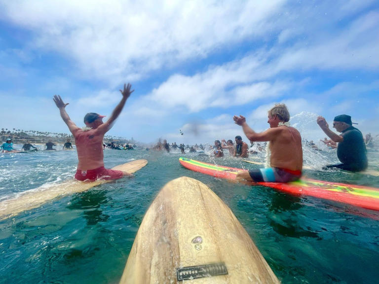 Surfers pay tribute to Mike Hynson with paddle out in La Jolla