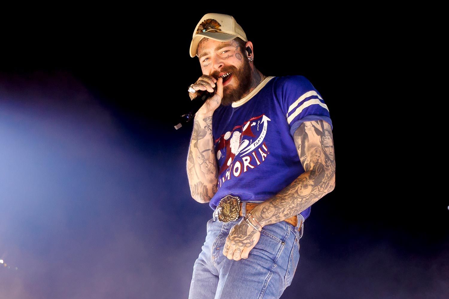 Post Malone falls off concert stage while reaching out to toast a fan