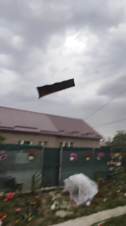 Piece of Sheet Metal Flies and Nearly Hits Person During Tornado in Romania