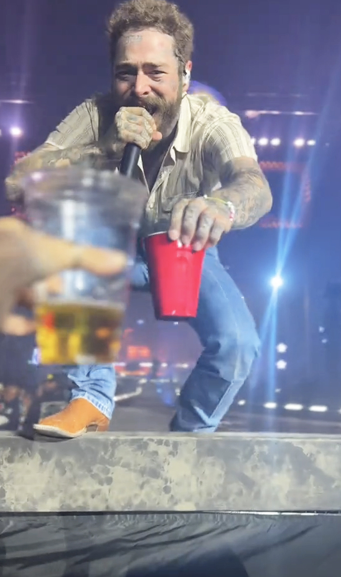 Post Malone takes nasty spill off concert stage while toasting fan with ...