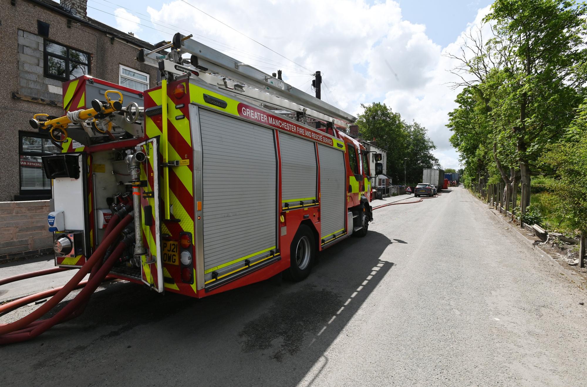Firefighters continue to tackle fire at 'illegal waste dump' in Wigan ...