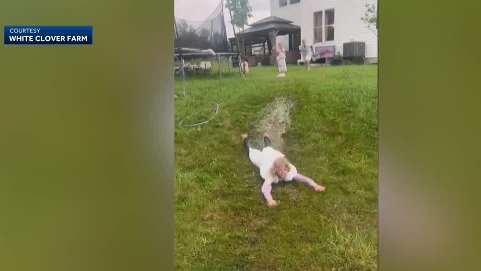 Kids giggle as they slide down muddy slip-and-slide at York County farm