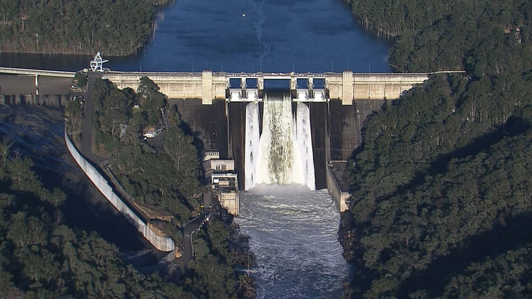 Warragamba Dam spills as NSW's major coastal weather event begins to ease