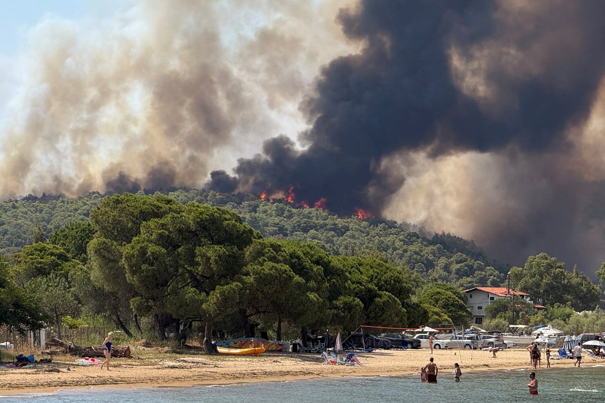At least 1,500 evacuated as massive wildfire rips through Greek holiday ...