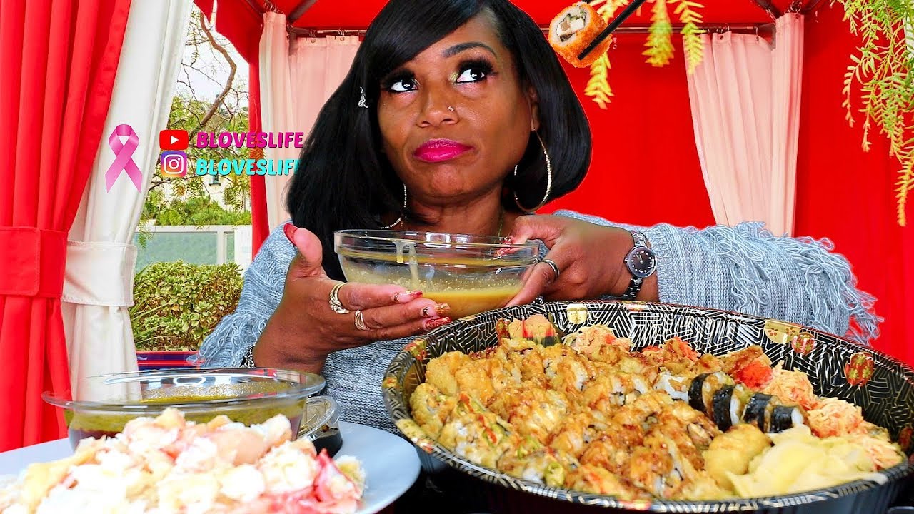 Deshelled king crab served alongside fresh sushi