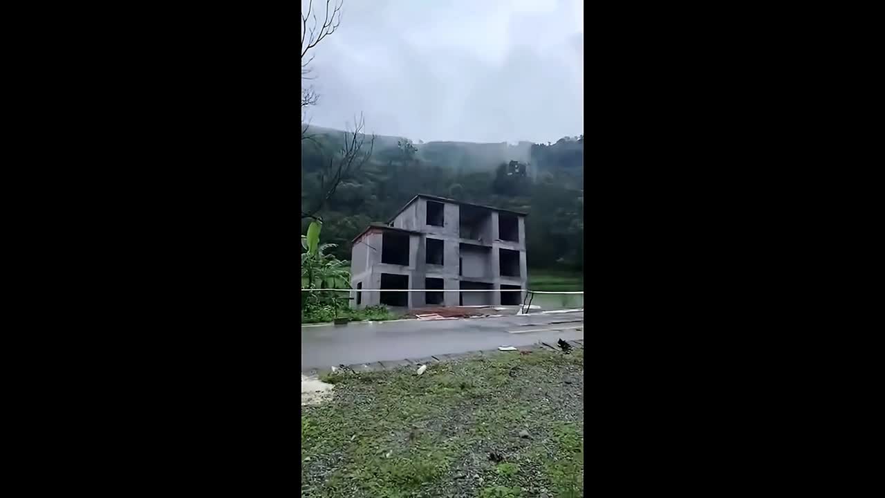 Five-storey homes collapses into river after torrential rain swells ...