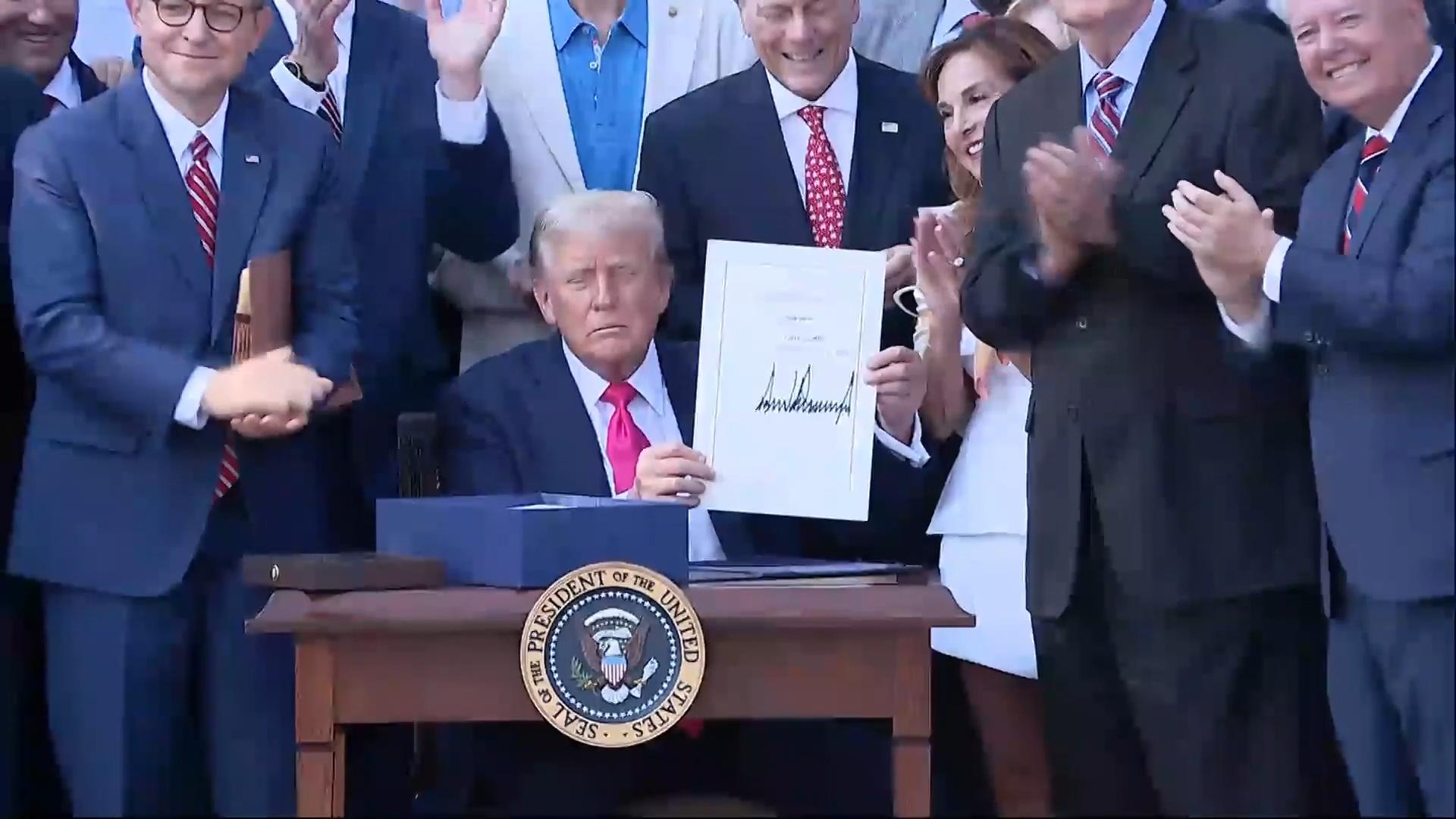 Trump signs his tax and spending cut bill at the White House July 4 picnic