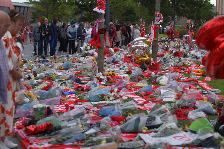 Diogo Jota's wife and Liverpool players visit sea of tributes laid ...