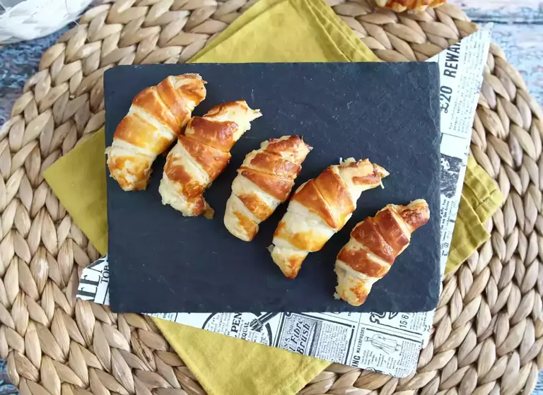 Puff pastry croissants with bechamel, ham, and cheese