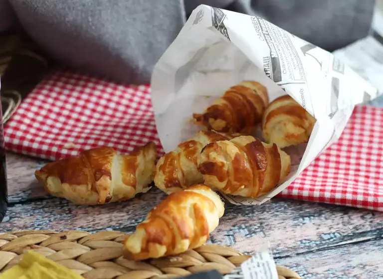 Puff pastry croissants with bechamel, ham, and cheese