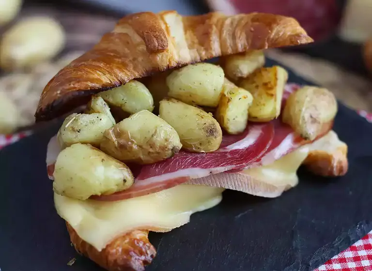Croissant con queso raclette y patata para un brunch gourmet