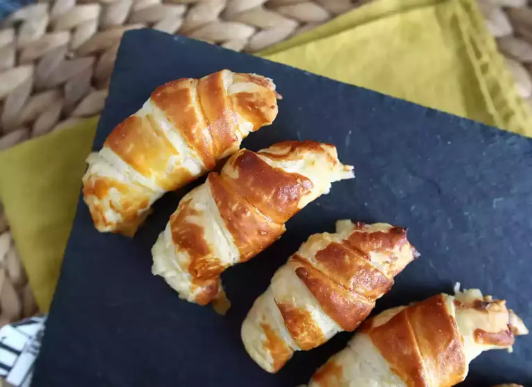 Puff pastry croissants with bechamel, ham, and cheese