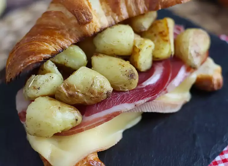 Croissant con queso raclette y patata para un brunch gourmet