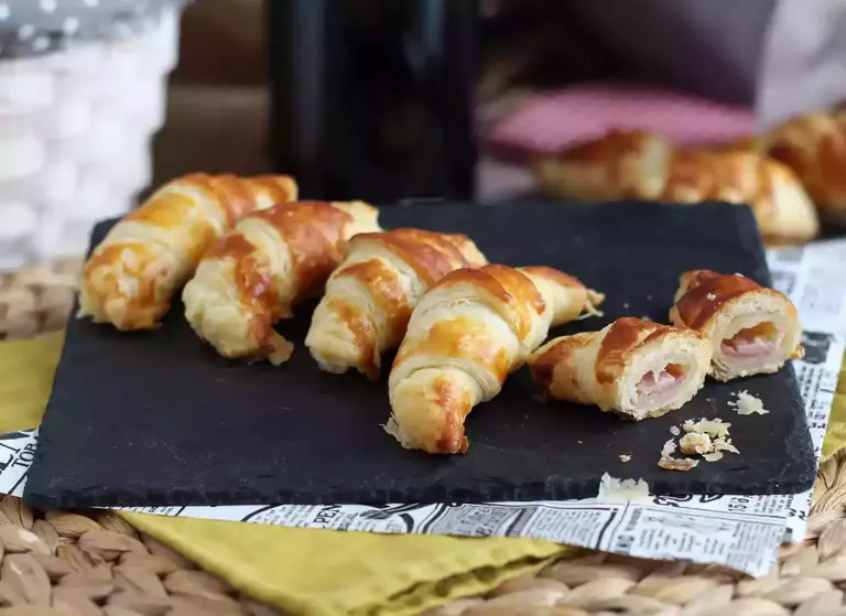 Puff pastry croissants with bechamel, ham, and cheese