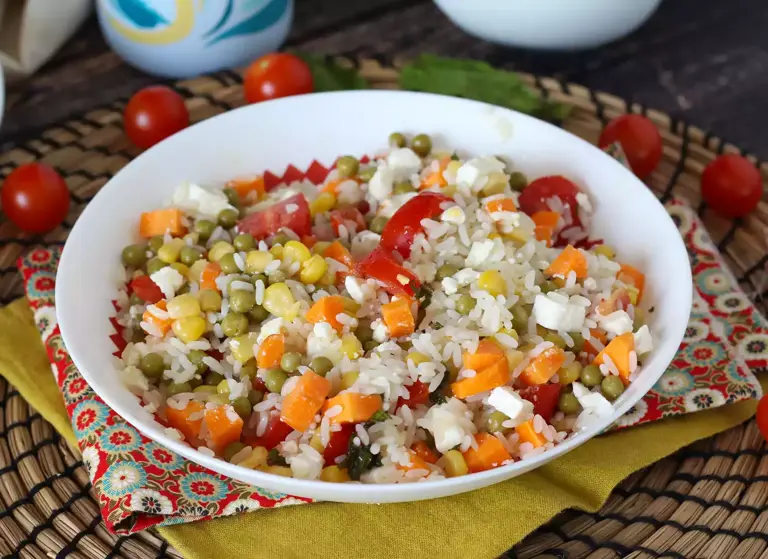 Ensalada de arroz vegetariana: maíz, queso feta, zanahorias, guisantes ...