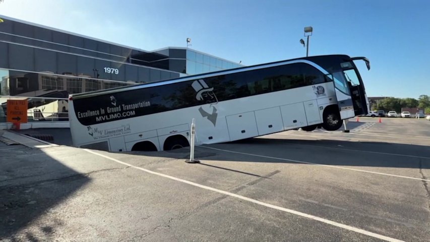 Coach bus partially falls into underground garage after collapse in ...