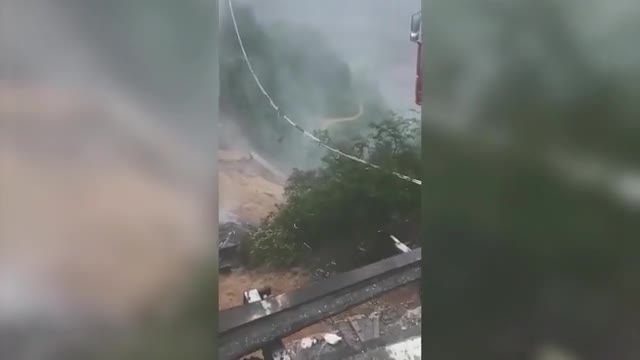 Watch: Lorry driver left dangling over edge of 700ft collapsed bridge ...