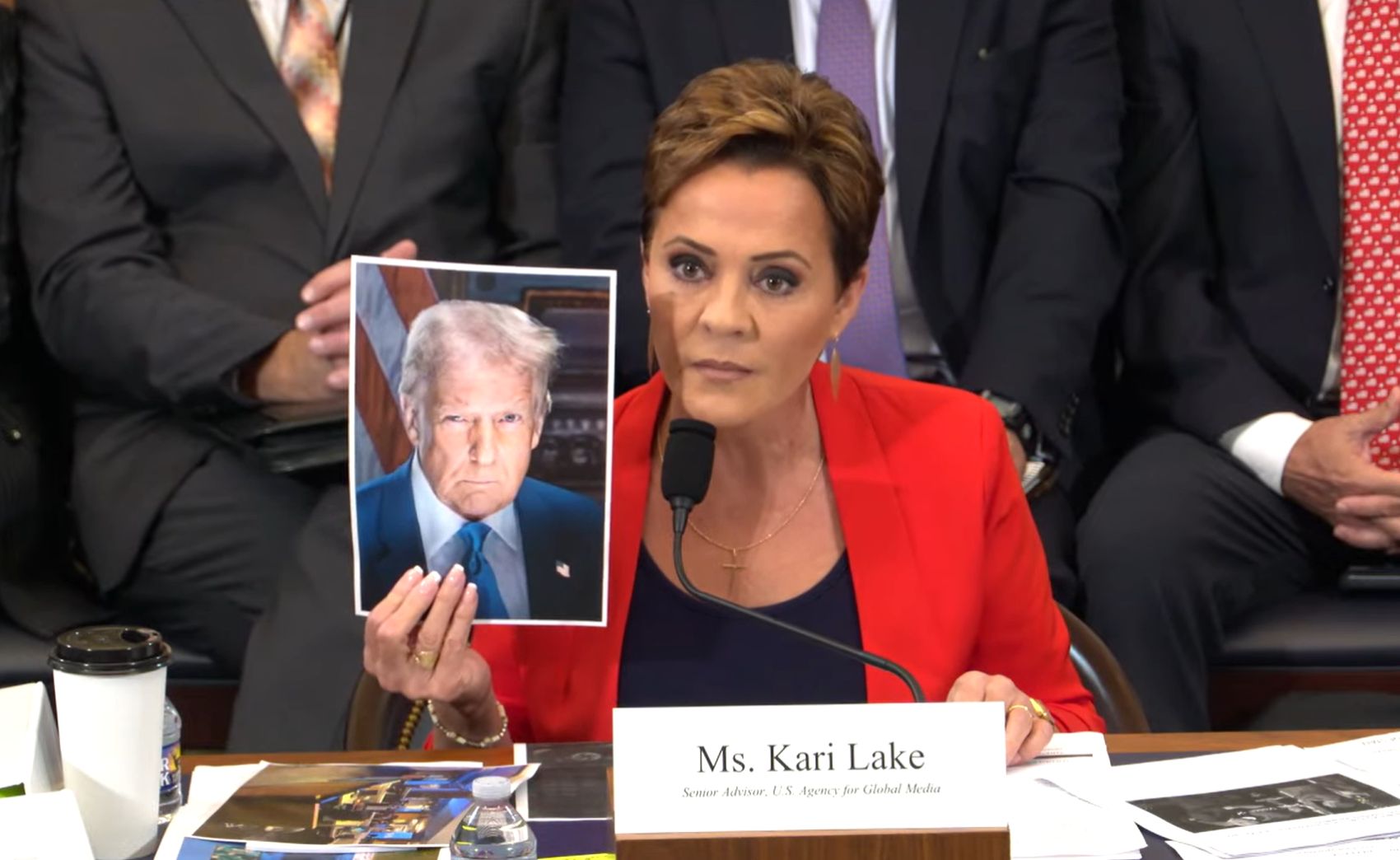 Trump Official Holds Up Trump's Picture After Being Questioned Over ...
