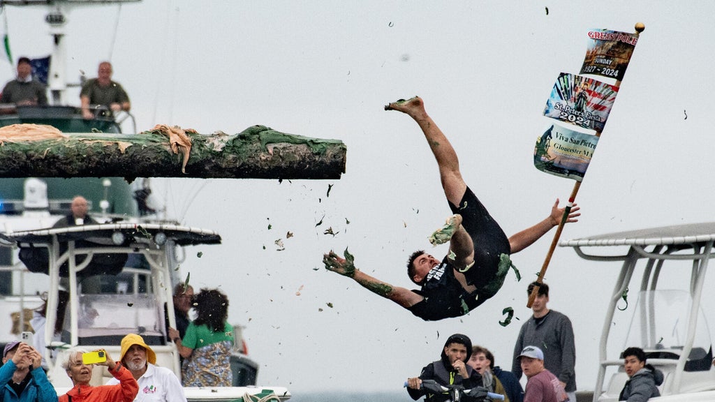 The greasy pole contest at St. Peter's Fiesta in Gloucester starts ...
