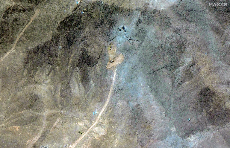 Satellite images appear to show excavators and bulldozers at work at ...