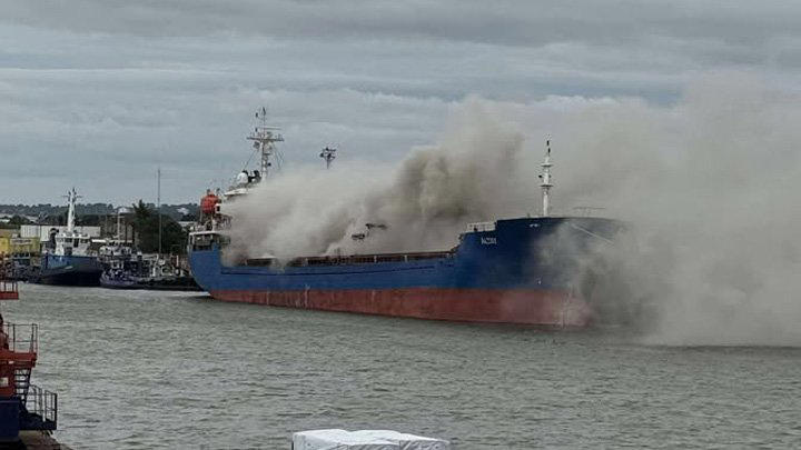 Fire on cargo ship sends smoke billowing into city