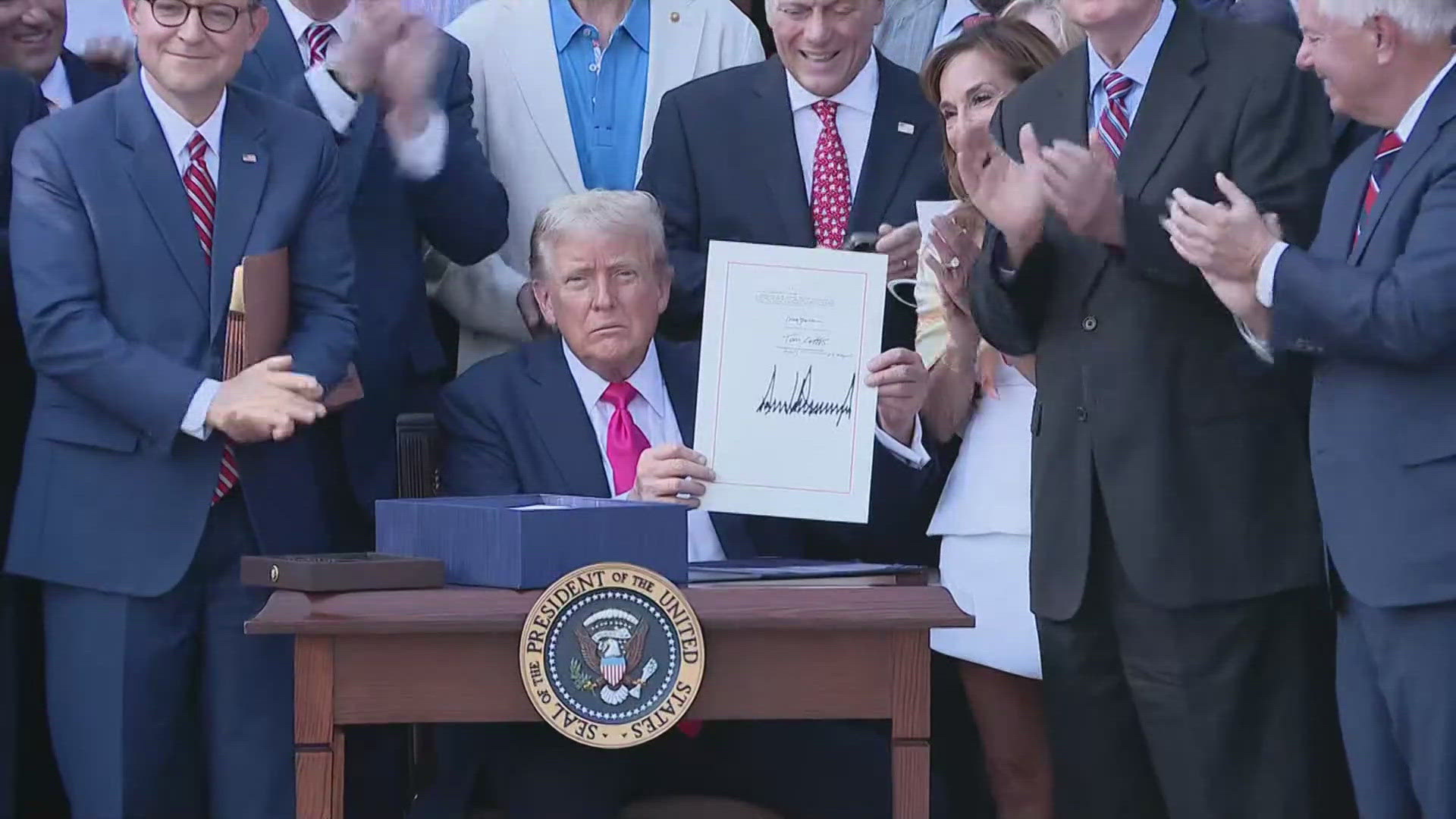 Trump signs his tax and spending cut bill at the White House July 4 picnic