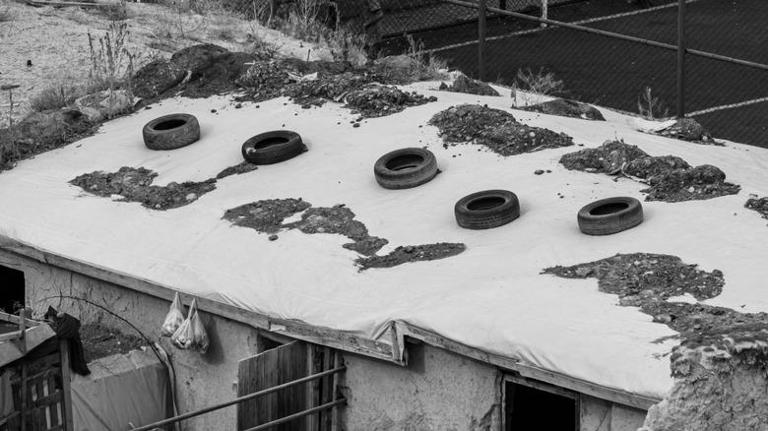 Here's Why You'll See People Put Tires On Their Roof Sometimes