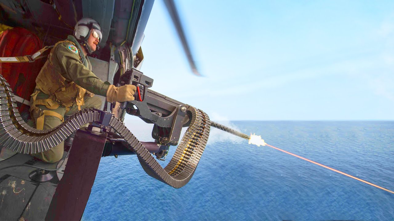 Helicopter door gunner operates powerful GAU-21 weapon system