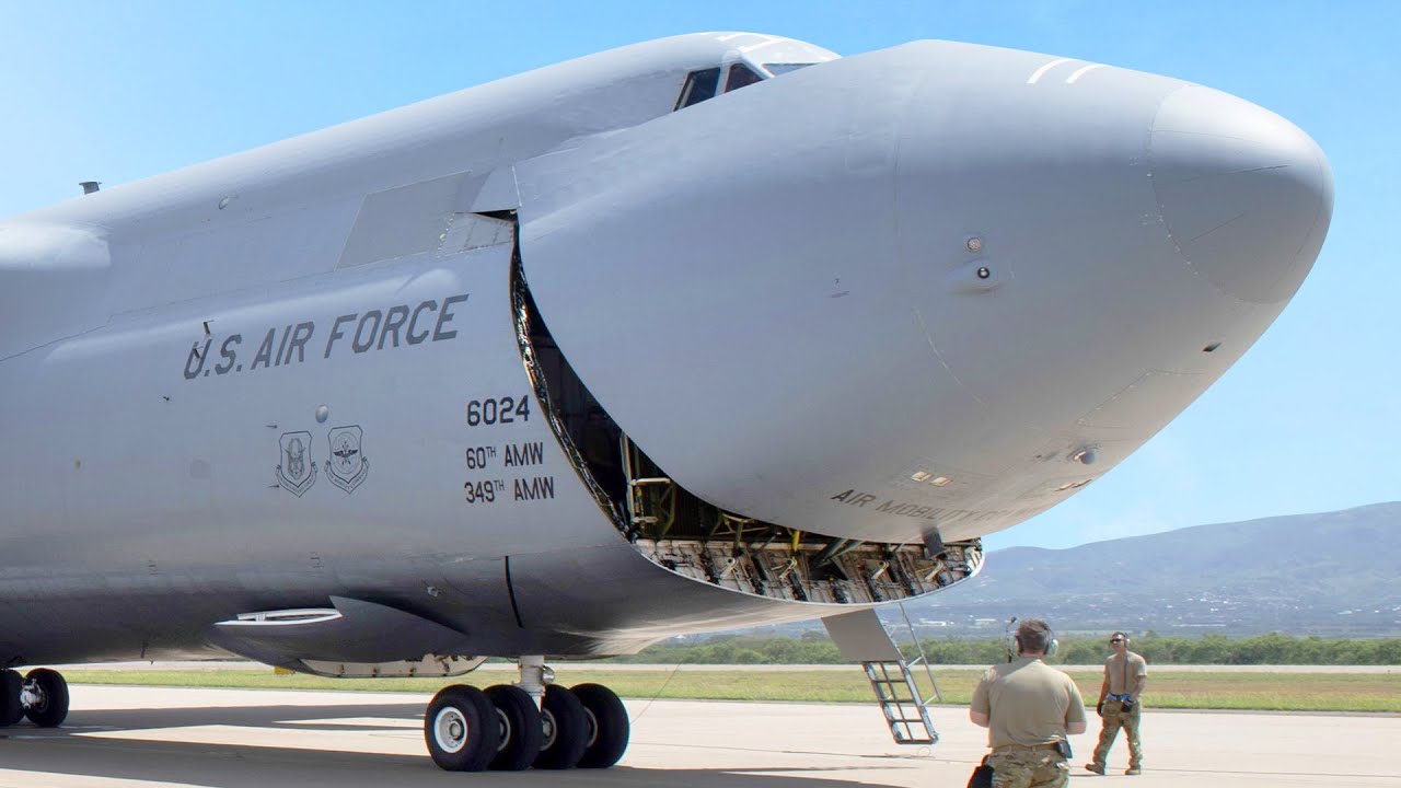 US Mega Plane Unloads Huge Trucks Through Its Nose
