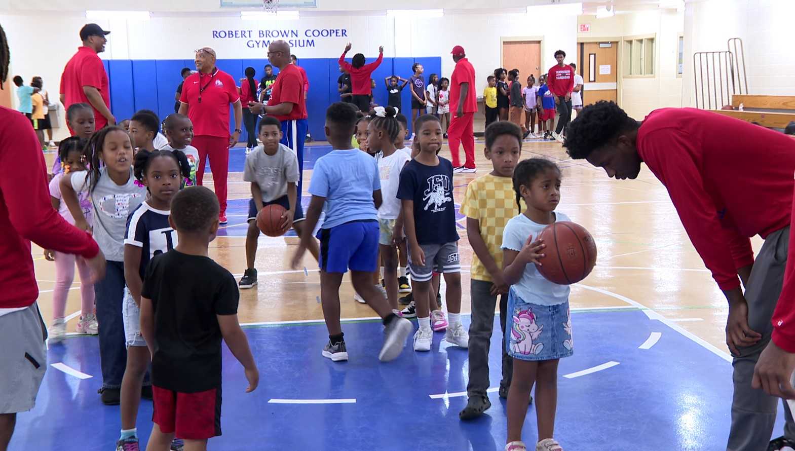 Children learn hoop skills at basketball clinic