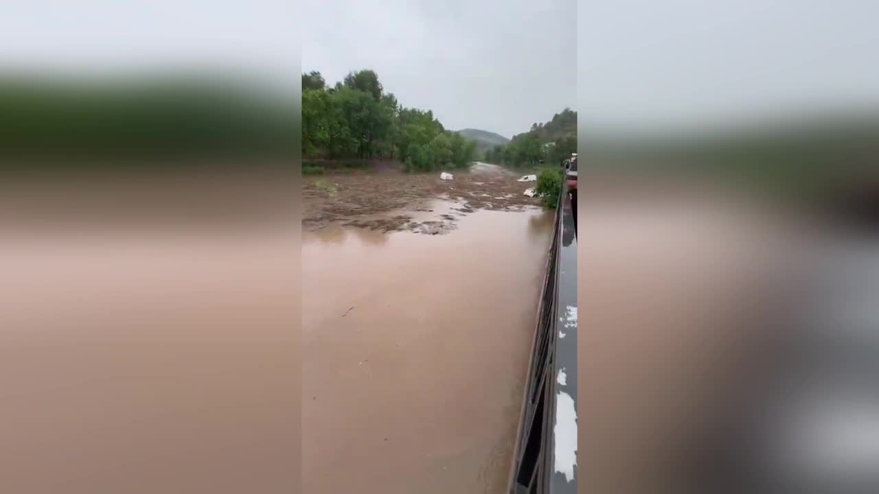 Cars float down river as floods hit northeast Spain