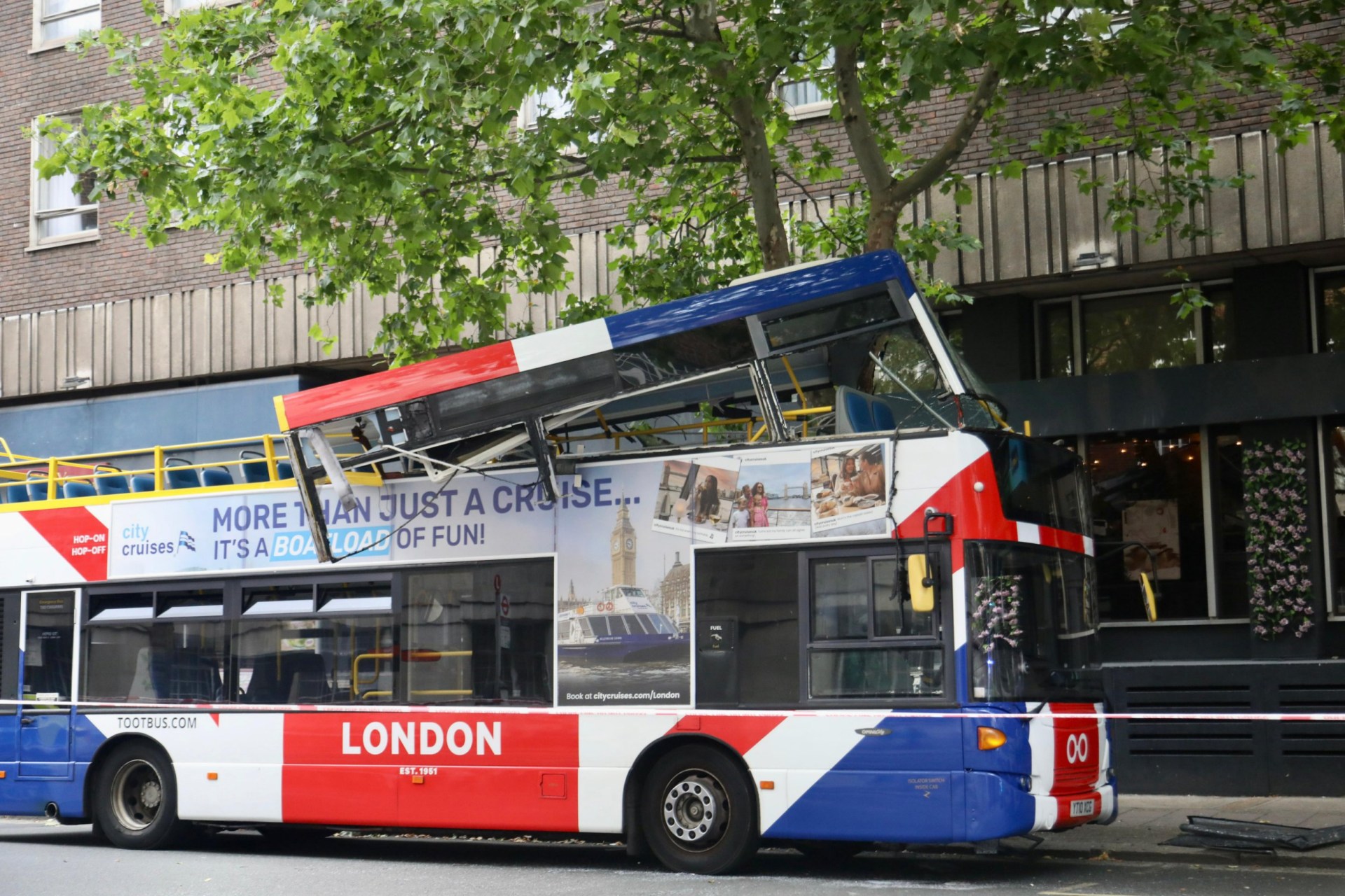 Open-top tourist bus smashes into tree in London