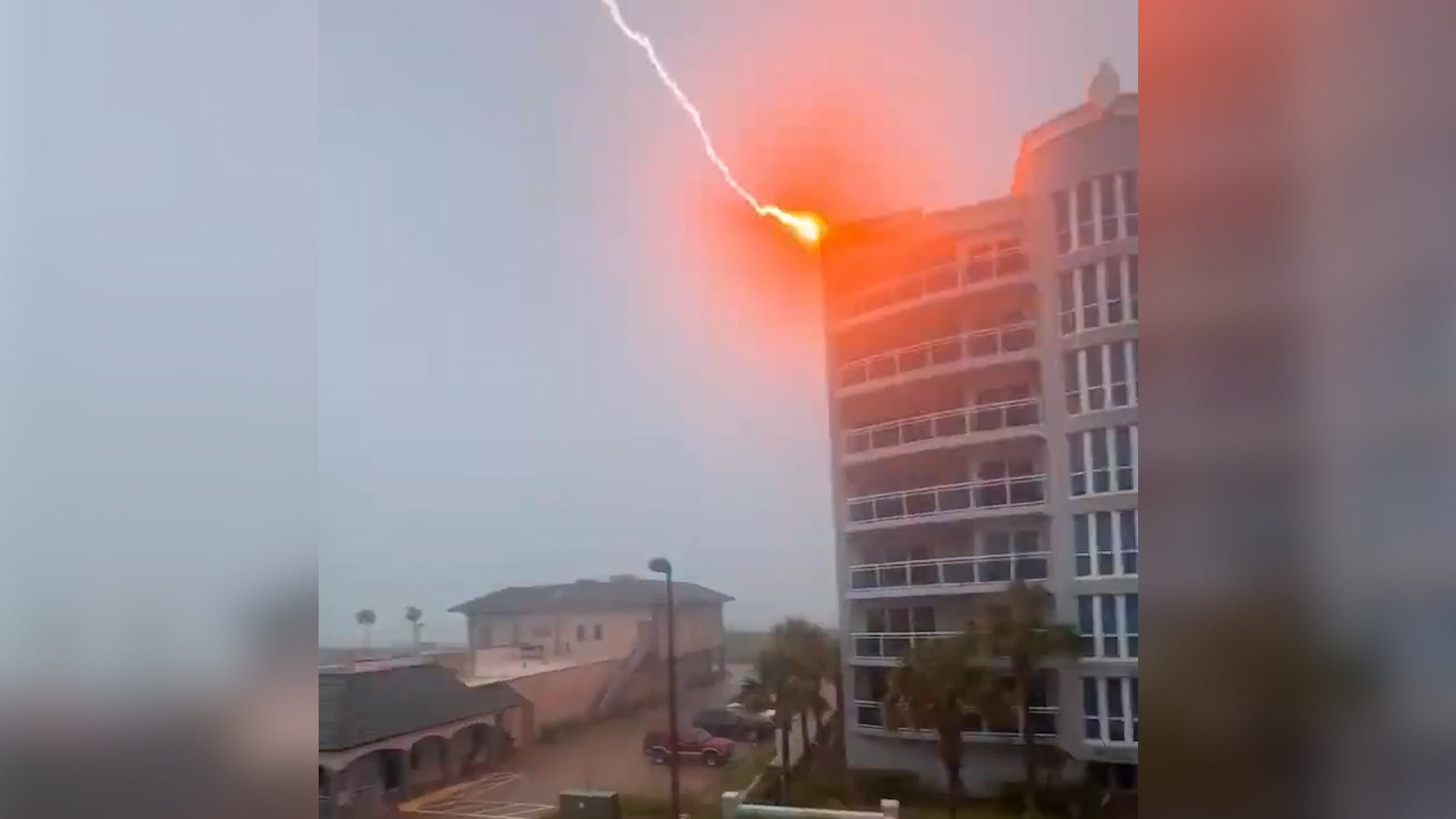 Shocking moment lightning strikes an apartment roof during a ...