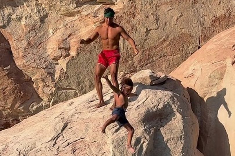 Terrifying moment travel influencer throws screaming son off cliff in ...