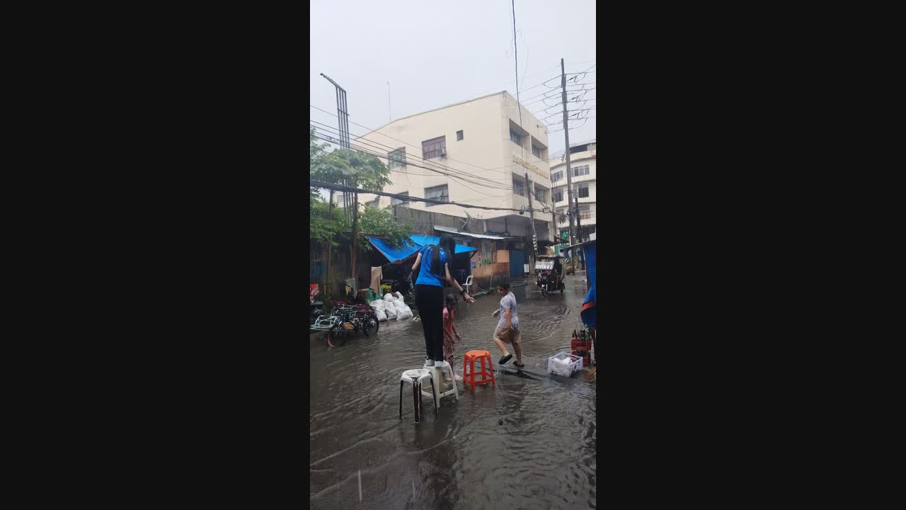 Children showering in the rain helps student cross flooded street using ...