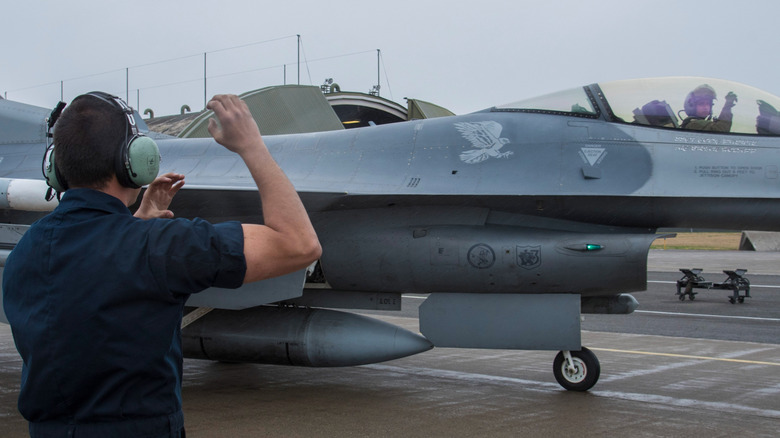 Why Do Fighter Pilots Give The 'Claw' Hand Signal? Here's What It Means