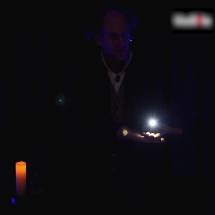 Magician Shows Cool Trick By Levitating Ball Of Light Out of Glass Bottle