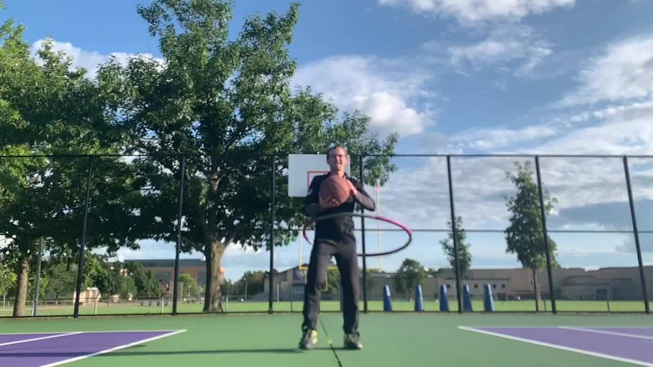 Man Performs Series of Trick Shots While Balancing Hula Hoop