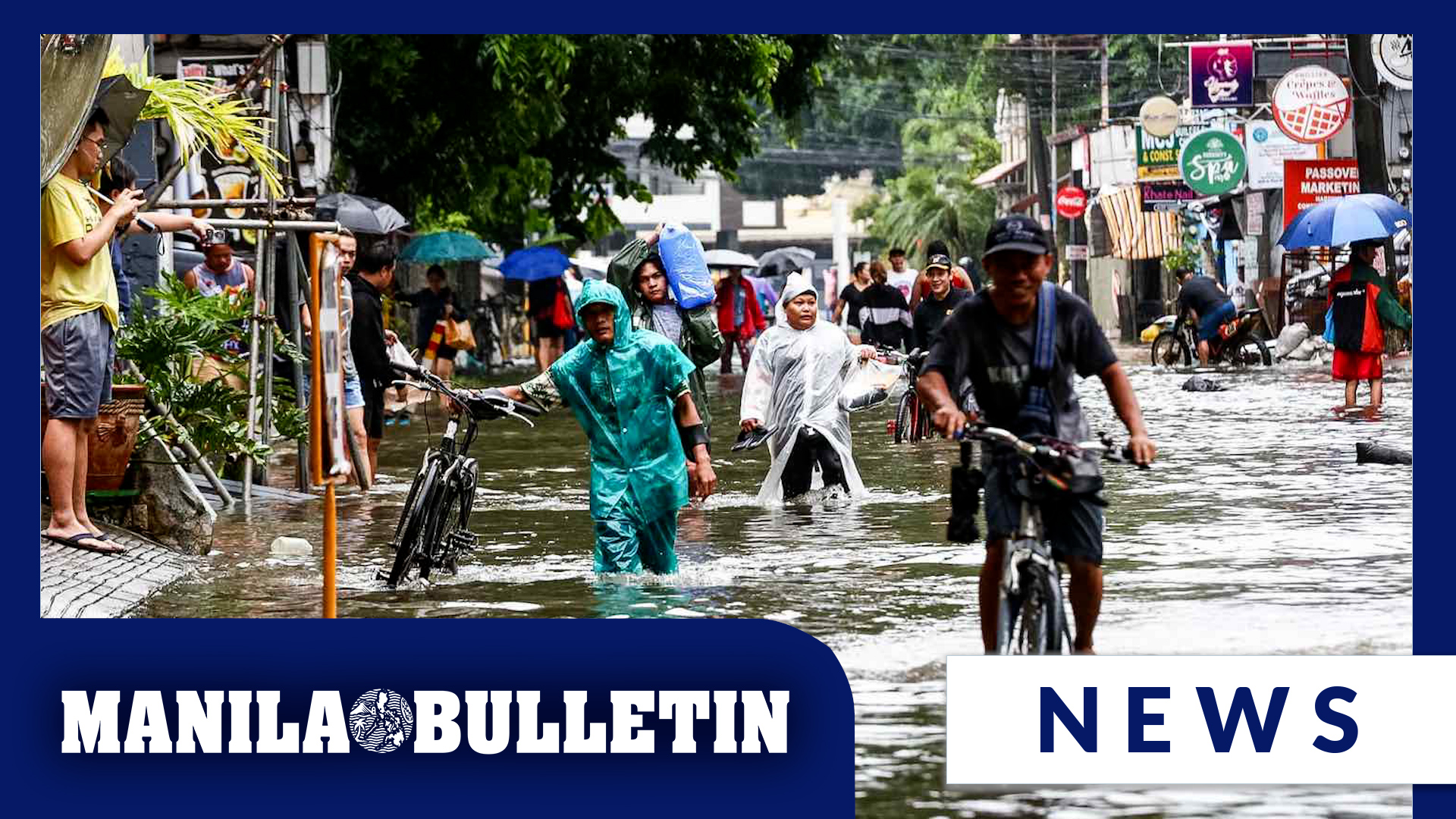 Residents traverse through floodwaters in Cainta, Rizal