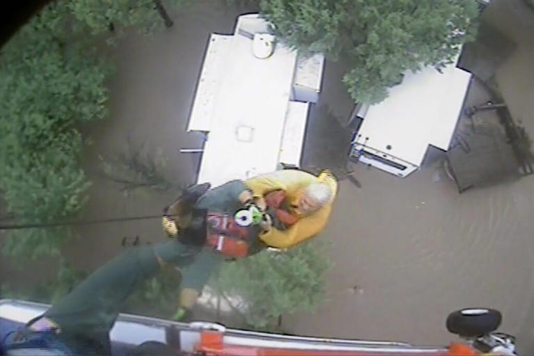Moment two people rescued from motorhome roof in Texas flash floods