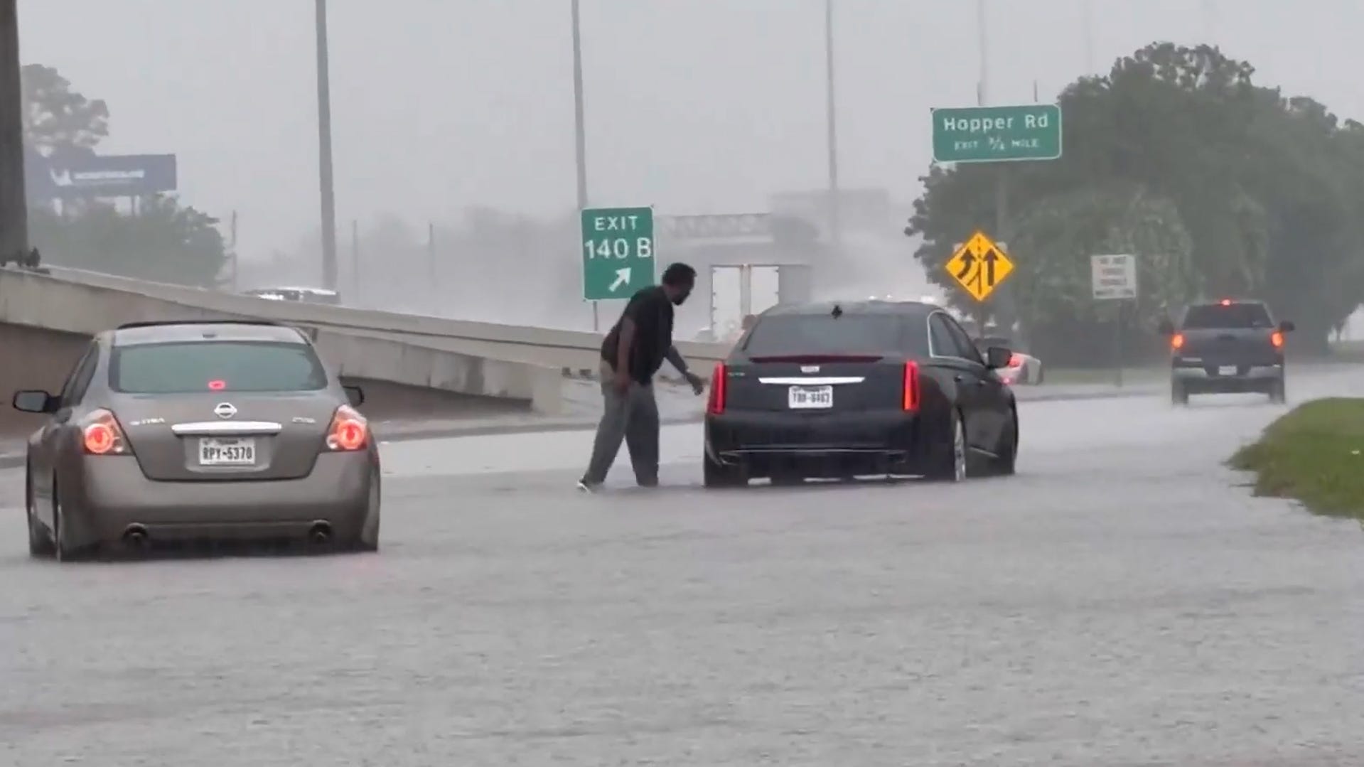 Cars were stranded along a highway in Houston after heavy downpours ...