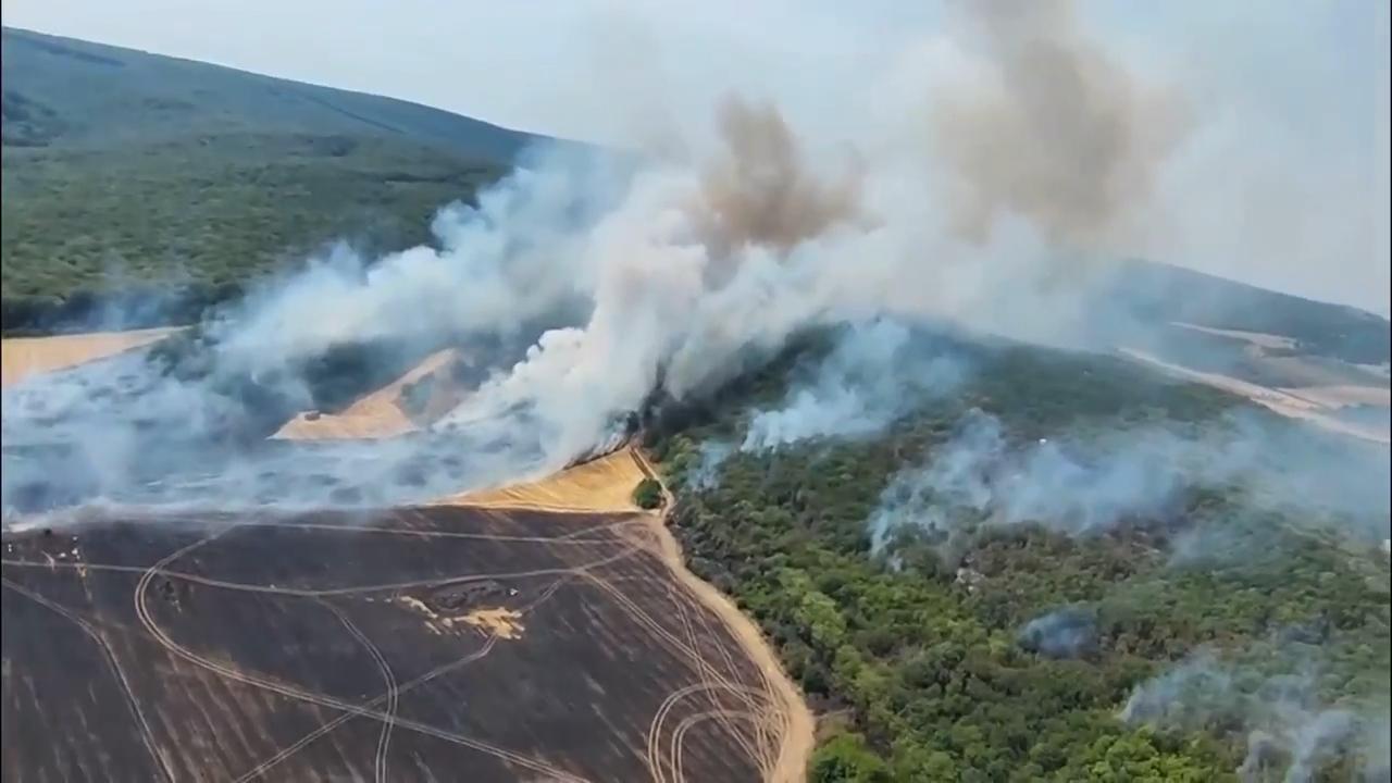 Romanian firefighters drop water on forest fires in country's east
