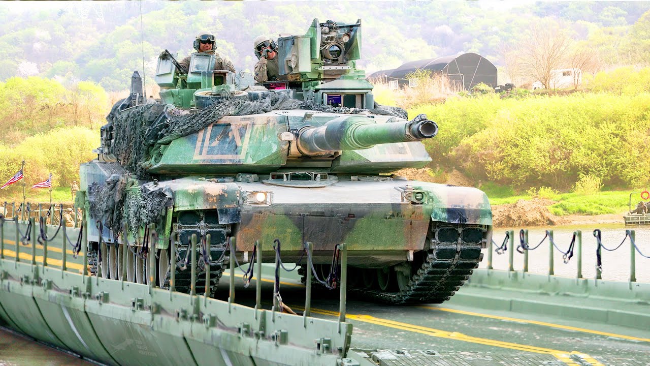 US and German heavy tanks navigate advanced floating bridge system