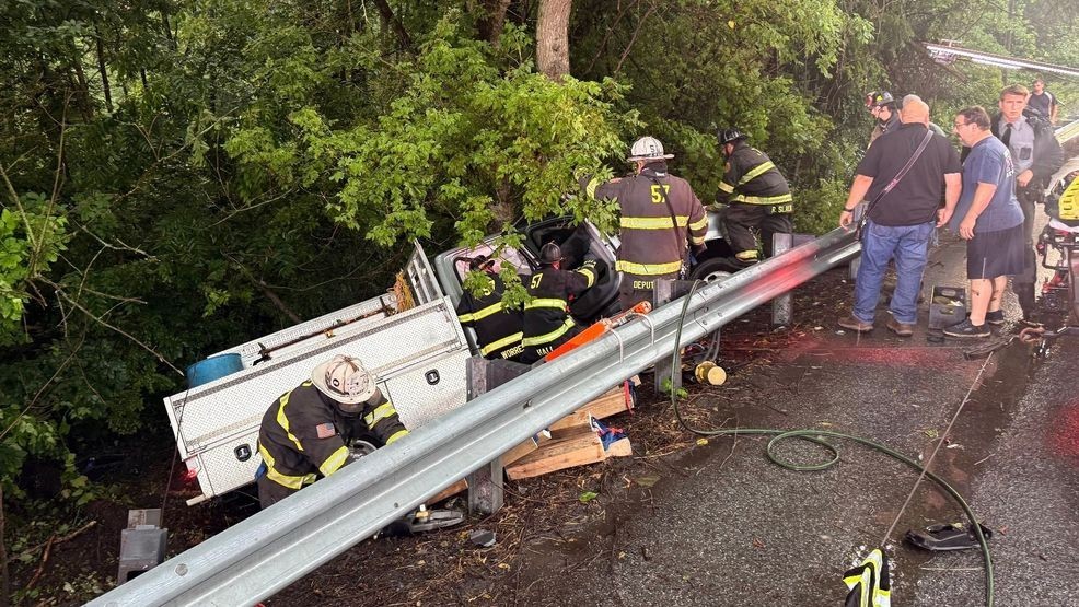 Crews remove truck's roof, doors to rescue driver who crashed down ...