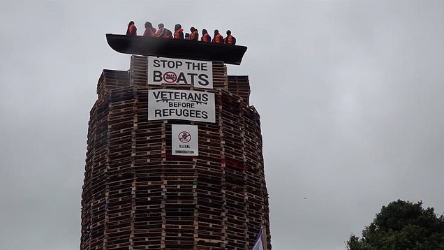 Calls for removal of migrant effigies in boat placed on bonfire in ...