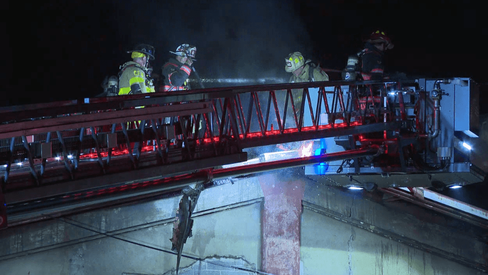 Dozens of firefighters battle warehouse blaze spotted by helicopter in ...