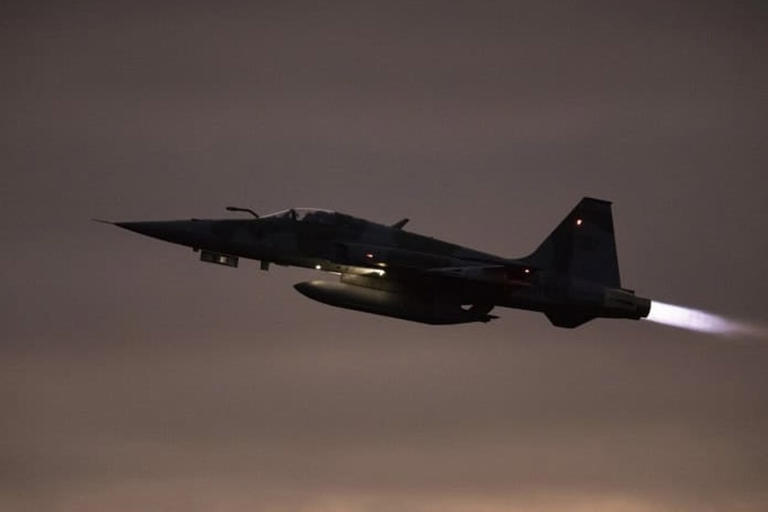 Brazilian Air Force planes conduct in-air refueling of fighter jets