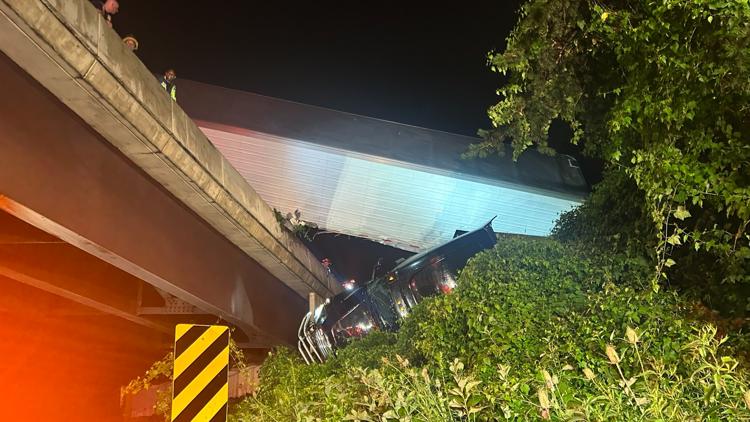 Crash leaves tractor-trailer dangling off a bridge on I-495 in Maryland