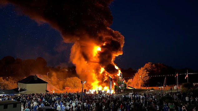 Moment 'racist' bonfire with migrants and a 'Stop the boats' sign at ...
